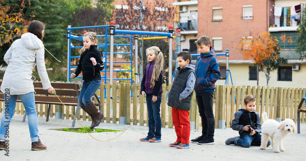 Children playing rubber band jumping game and laughing Stock Photo ...