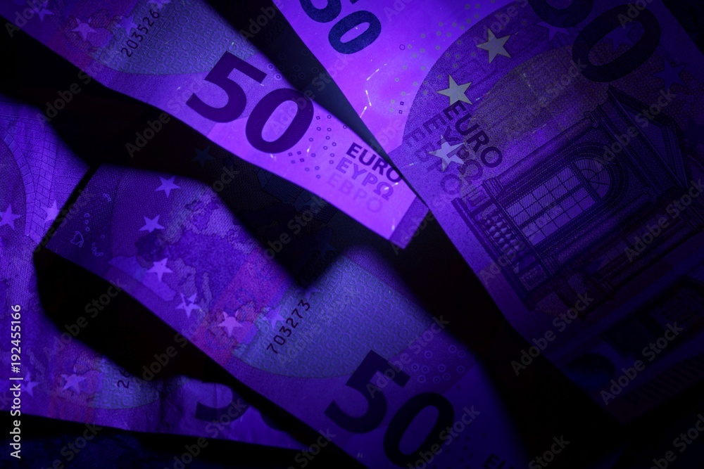 Banknotes in UV light. Stock Photo | Adobe Stock