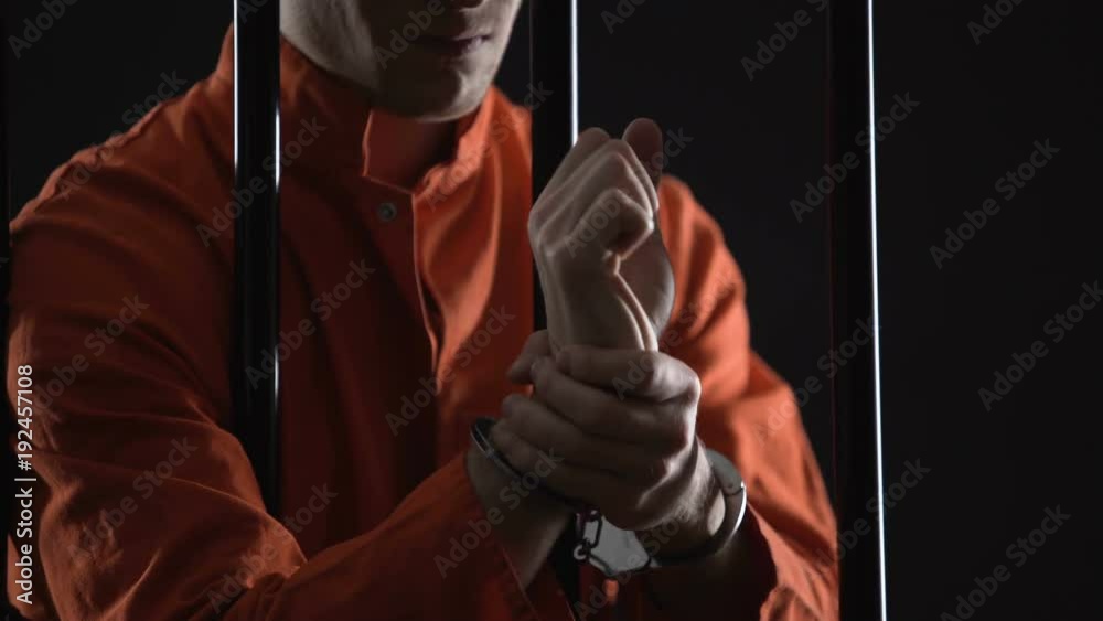 Inmate in handcuffs rubbing wrists, inhuman conditions and tortures in ...