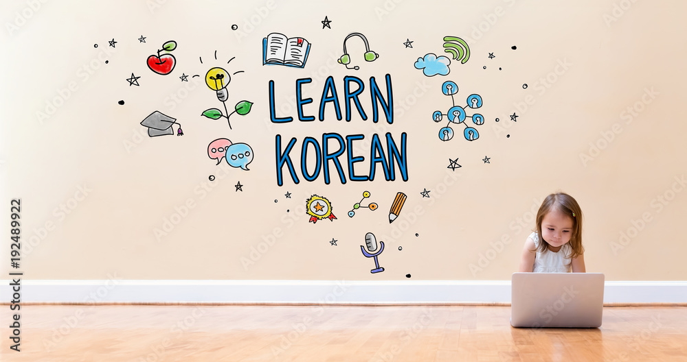 Learn Korean text with little girl using a laptop computer on floor ...