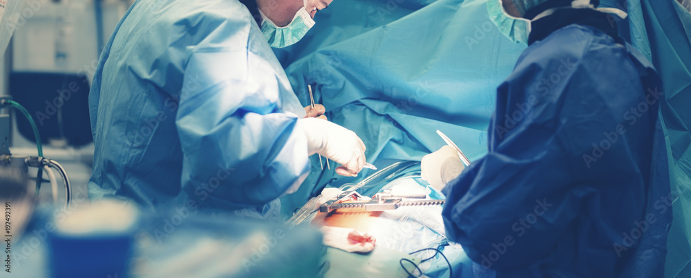 Medical team of surgeons in hospital doing minimal invasive surgical ...