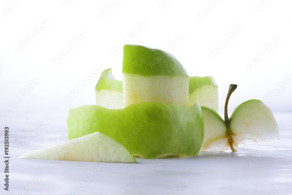 Green peeled apple, apple skin, fruit, healthy food, yak on a light ...