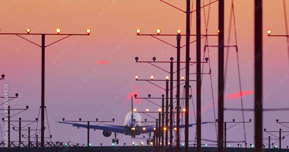 Commercial jet airplane plane landing in airport at sunset Los Angeles ...
