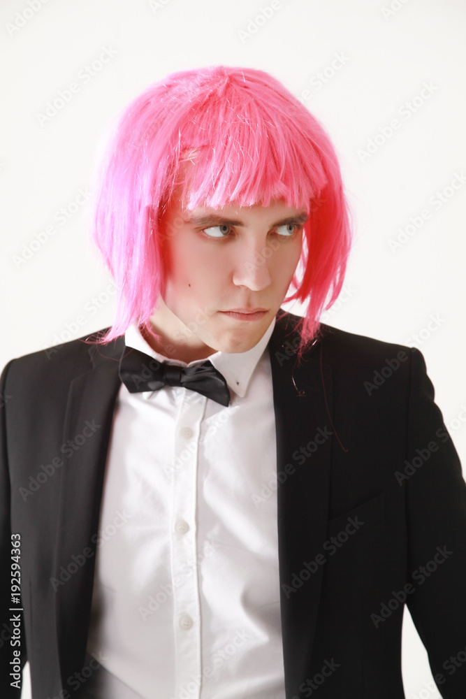 stylish and funny young guy standing in business suit and pink women ...