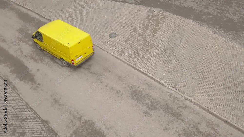 Yellow minibus moving along asphalt road. Yellow passenger van driving ...