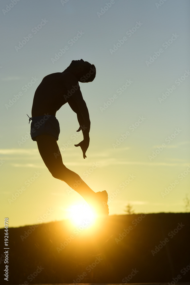 Healthy lifestyle and sport concept. Silhouette of athlete jumping ...