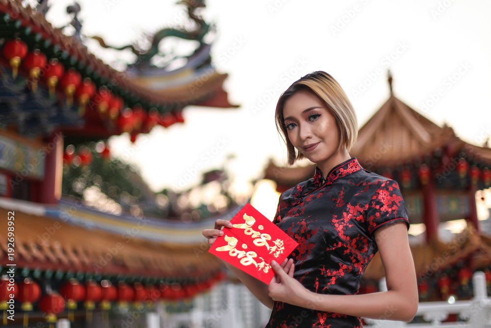 asian lady wearing traditional cheongsam dress with temple and lantern ...