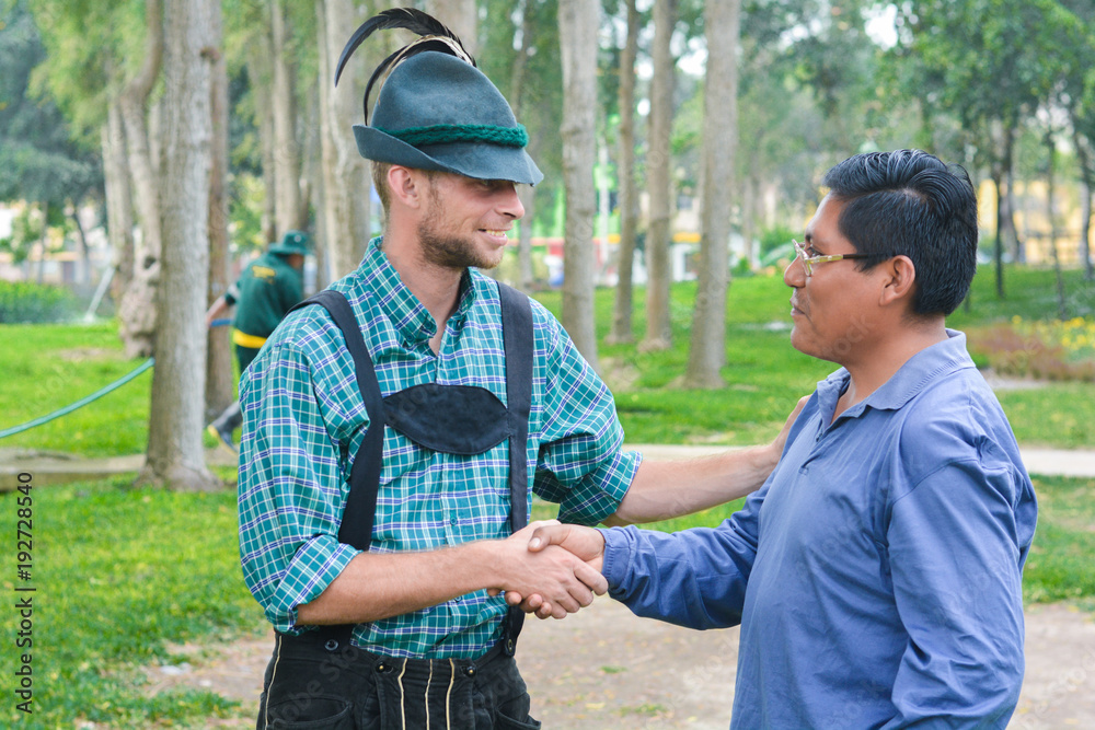 Interracial friendship - happy caucasian and native american men giving ...