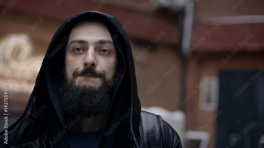 portrait of mysterious man in black cloak with a beard is on a frosty ...