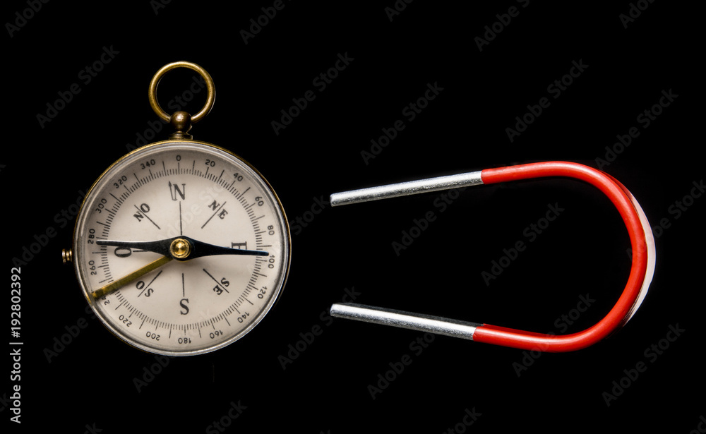 Magnet deviates a compass. Concept of fake news. Isolated on black ...