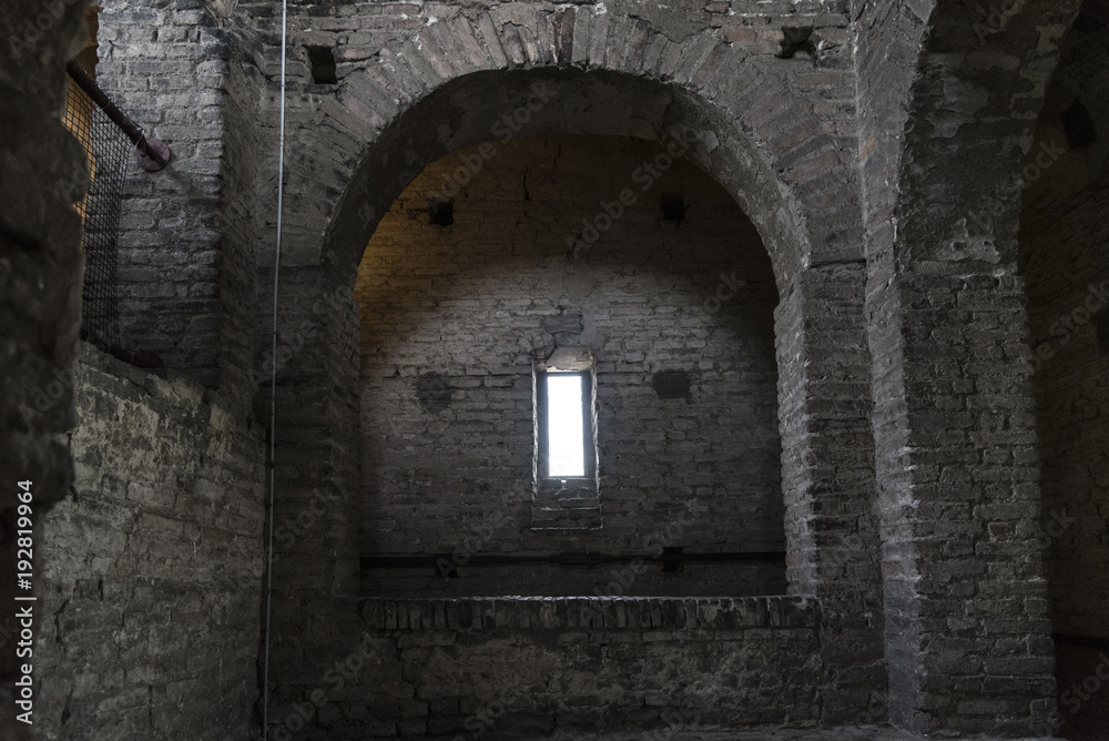 Stone interior with window of an old steeple crypt, located inside an ...