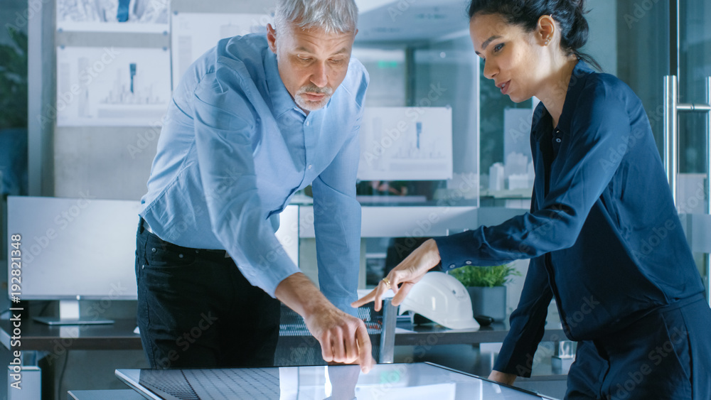 Senior Male and Young Female Architectural Designers Draw Building ...