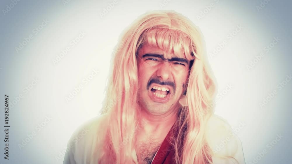 An ugly nerd dressed as a saint with a tunic and a blonde wig ...