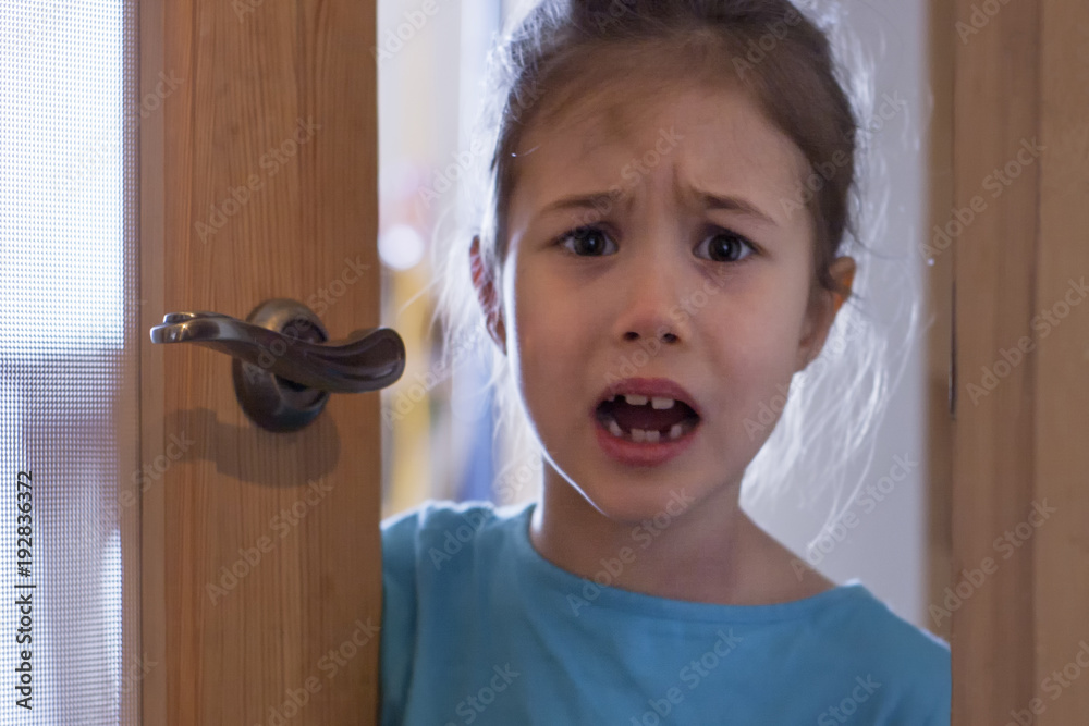 An angry child closes the door of his room from his parents Stock Photo ...