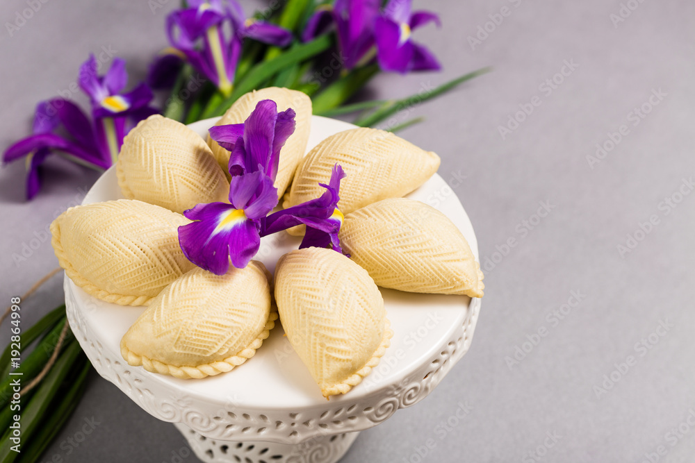 Novruz traditional pastry shekerbura in round white plate cake stand ...