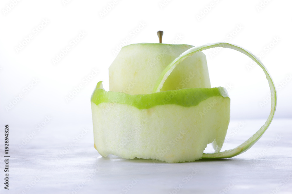 Green peeled apple, apple skin, fruit, healthy food, yak on a light ...