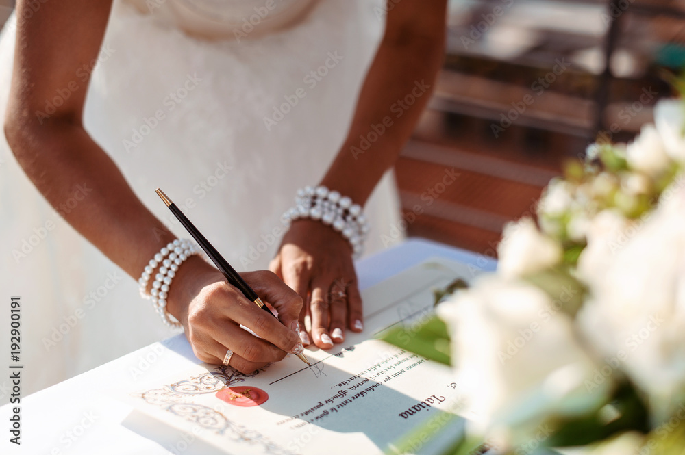 The bride signs the marriage registration documents. Young couple ...