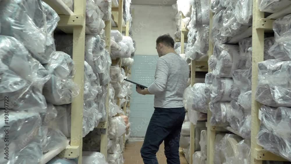 Vidéo Stock Auditor Counts Merchandise in Warehouse. He Walks Through ...