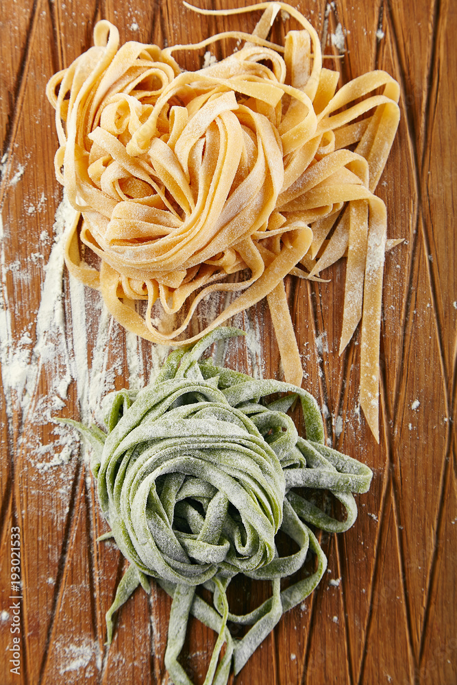 Two types of handmade italian tagliatelle pasta: classical one and ...