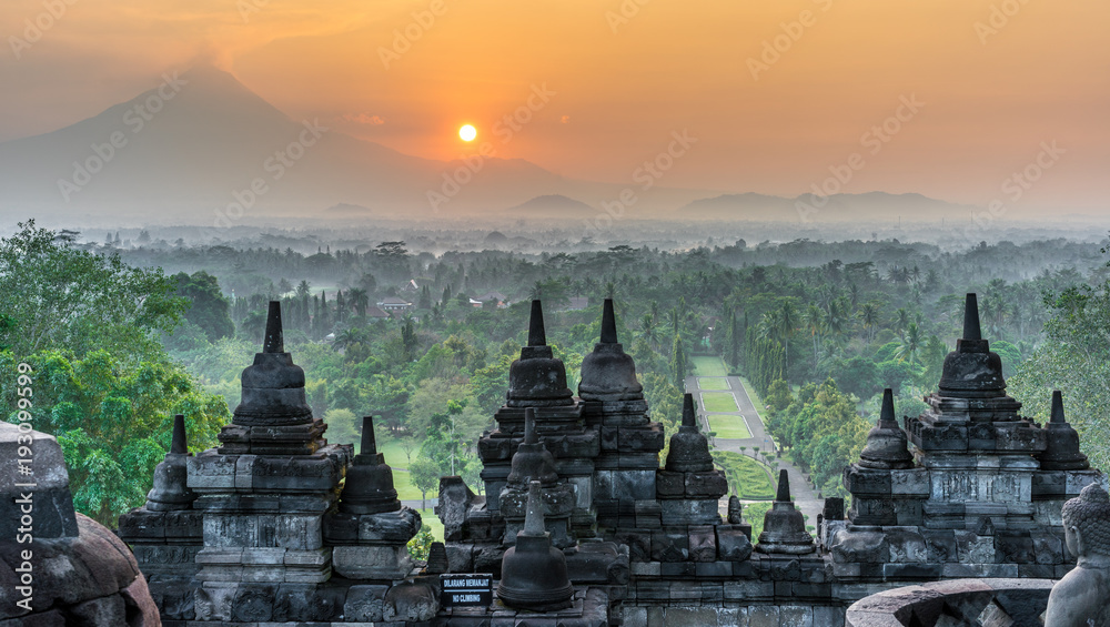 Sunrise panorama of Mount Merapi, Borobudur valey covered with mist and ...