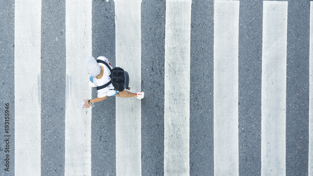 the top plan view of man walk across the pedestrian crosswalk in white ...