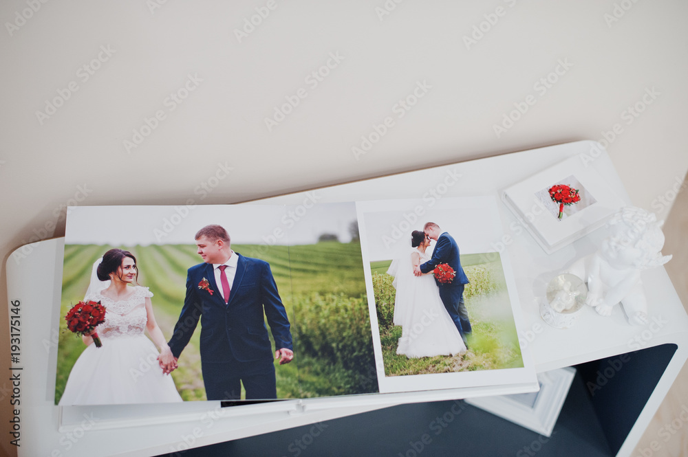 Pages of elegant photobook or wedding album on a small table. Stock ...