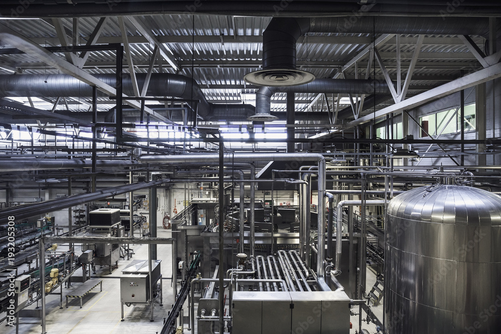 Modern brewery plant. Huge tanks or vat for beer fermentation ...