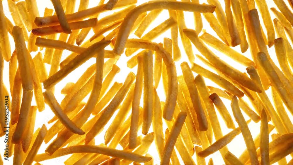 Fried potato chips rotating on white background in 4K. Yummy french ...