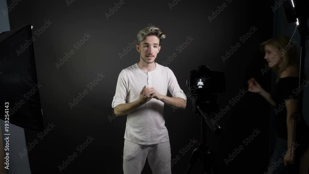 Young smiling vlogger man shooting for his vlog in a professional ...