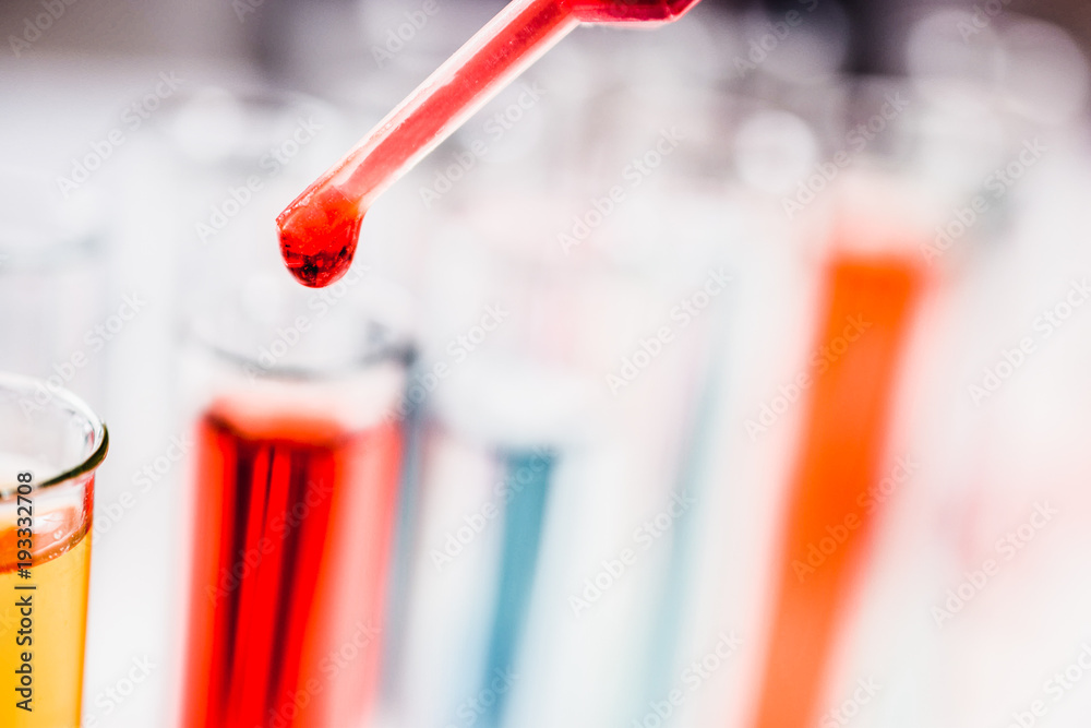 test tube and pipette with a sample drop. laboratory science background ...