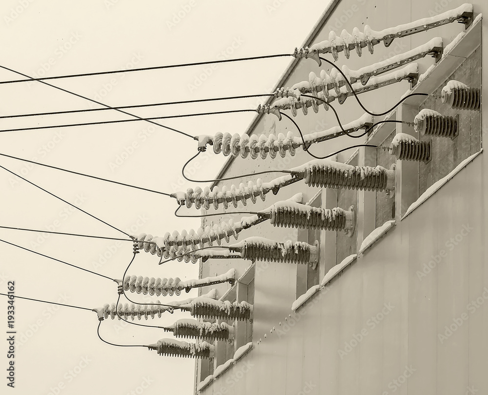 insulators and electrical wires at electrical substation with ...