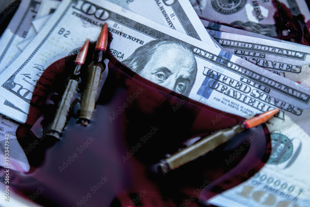 Contract killing and murder for money. Bullets on dollar bills as ...