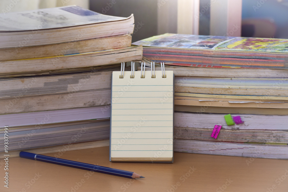 Notepad with pencil on wood board background.using wallpaper for ...