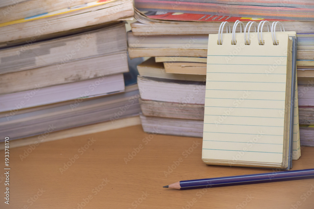 Notepad with pencil on wood board background.using wallpaper for ...