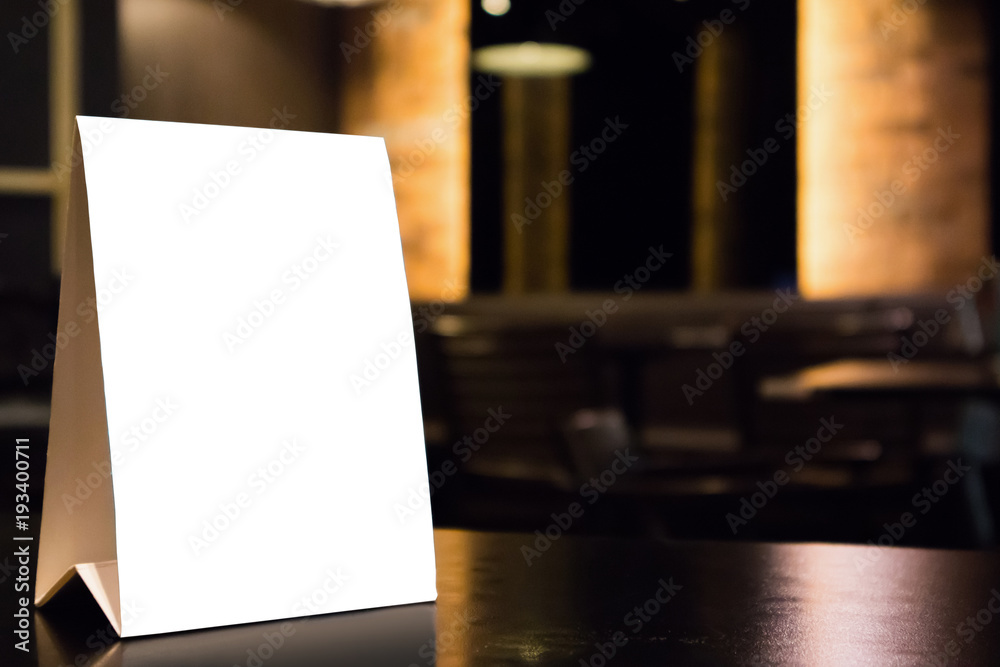 Mockup white label menu frame on table with cafe restaurant interior ...