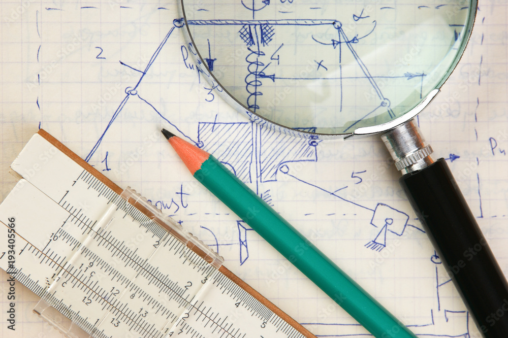 magnifying glass and a slide rule on the old page with the calculations ...