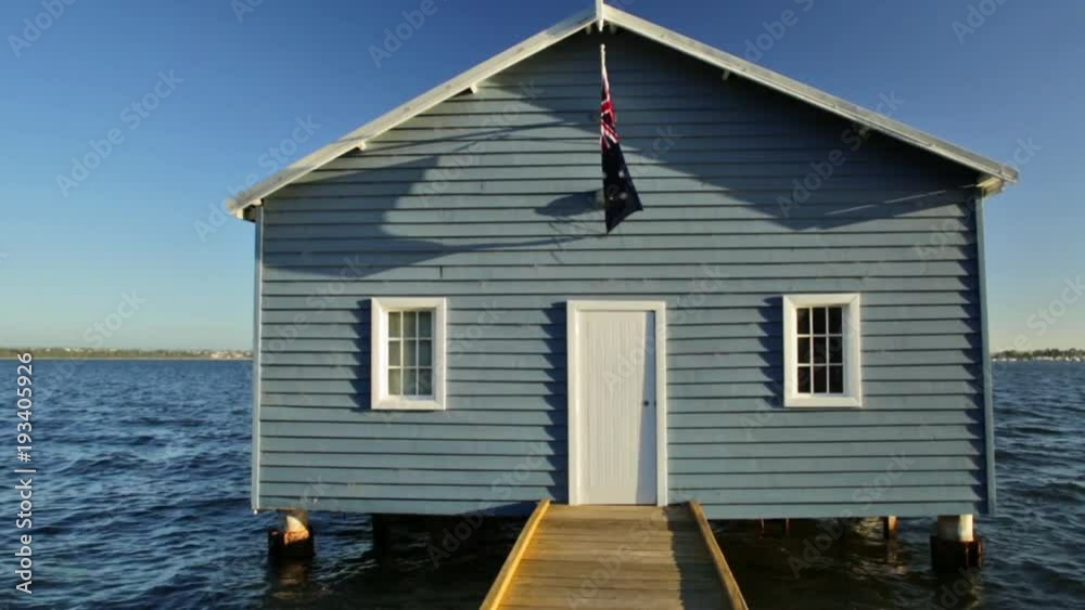 The iconic landscape of blue boat house from 1930s with wooden jetty on ...