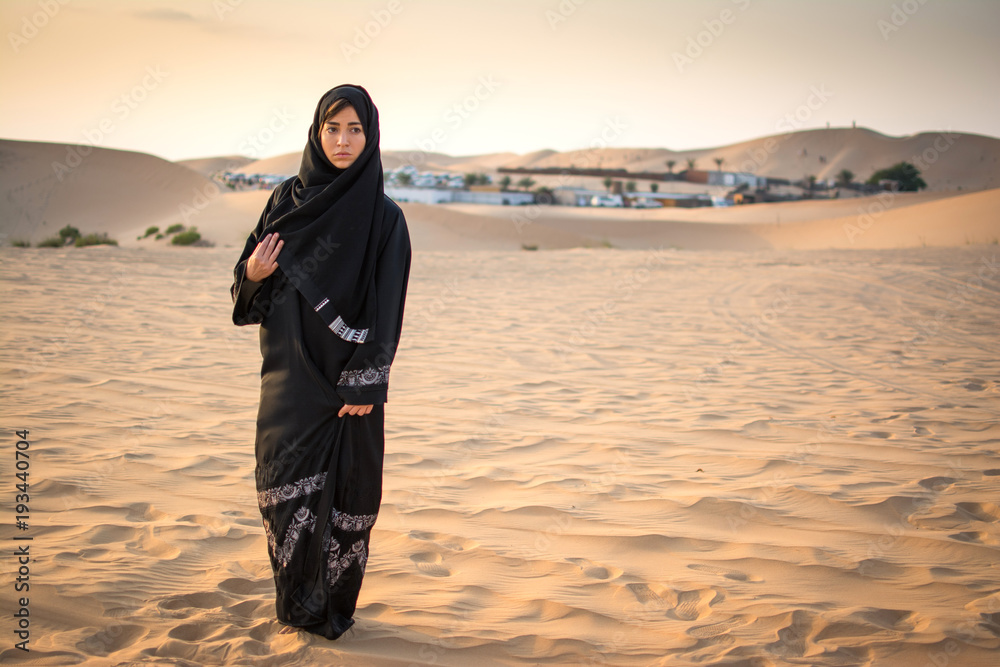 Full length portrait of Arabic woman in traditional black clothes ...