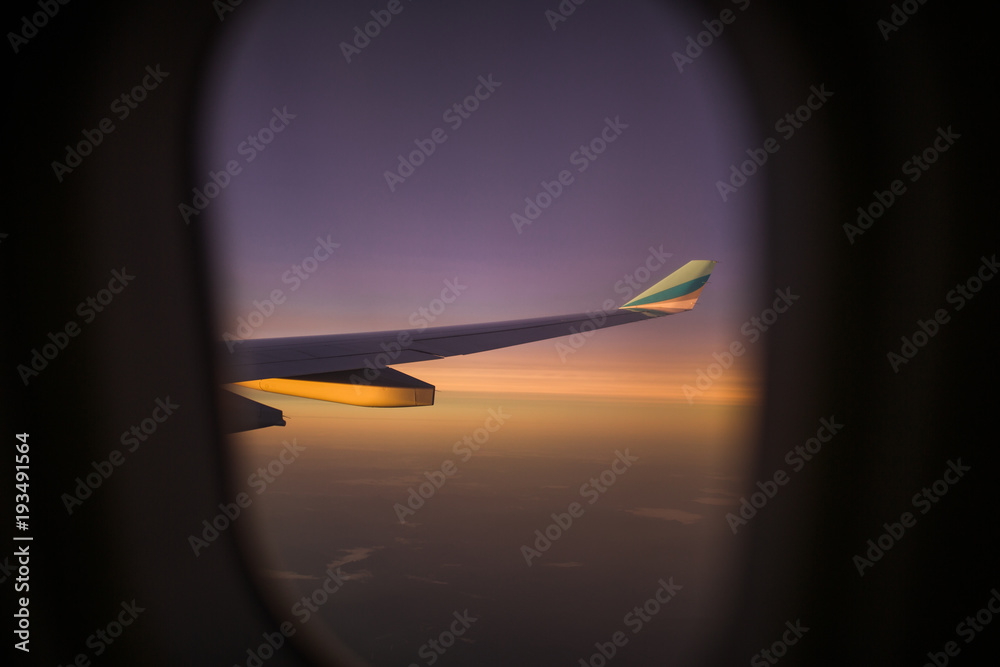 Airplane wing seen through airplane window Stock Photo | Adobe Stock
