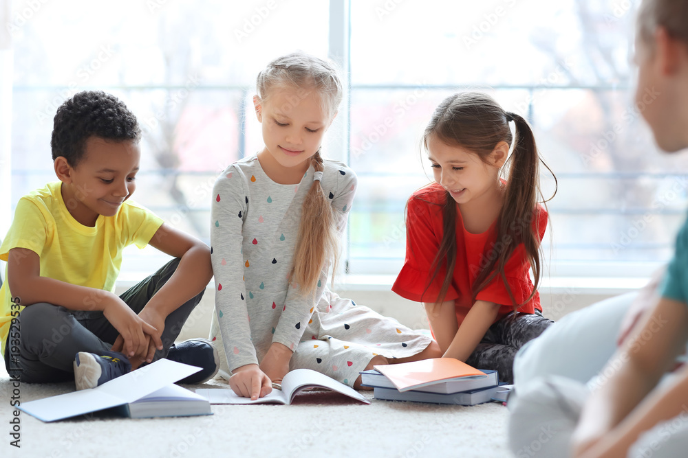 Cute children doing homework in classroom at school Stock Photo | Adobe ...