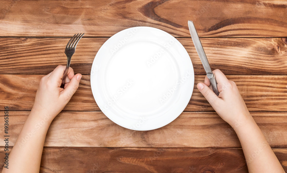Hungry child waiting for meal. Child's hands holding fork and knife ...