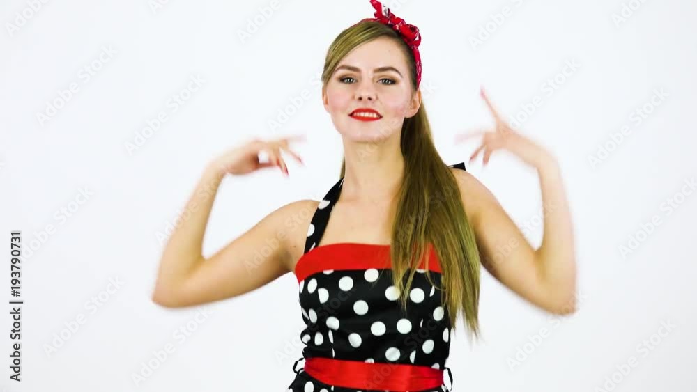 A beautiful 50s pin-up girl dances and smiles at the camera - white ...