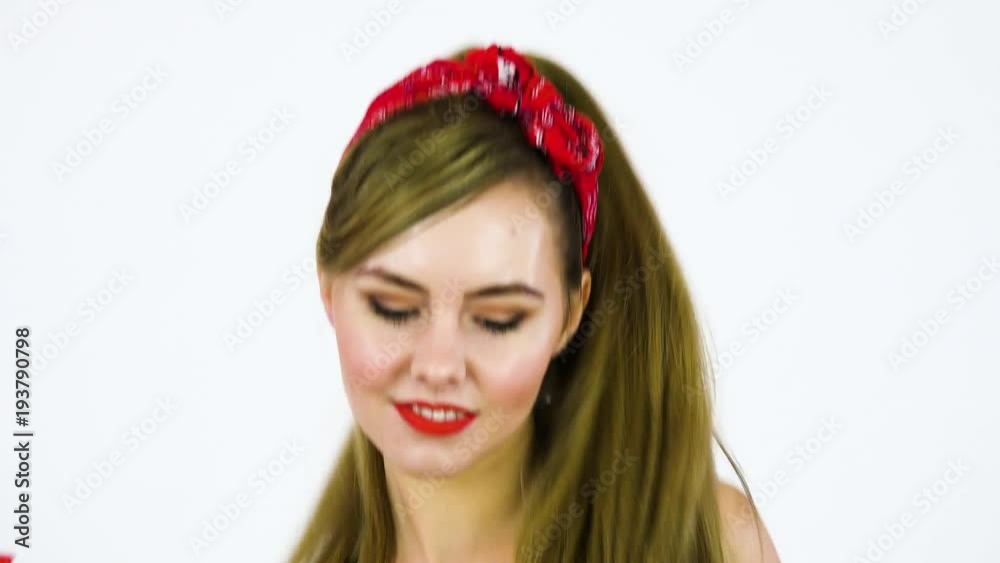 A beautiful 50s pin-up girl dances and smiles at the camera - closeup ...