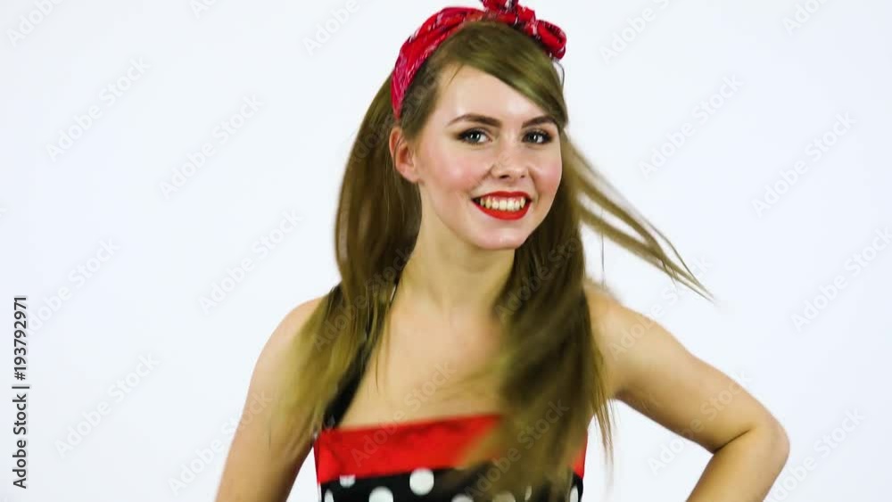A beautiful 50s pin-up girl dances and smiles at the camera - white ...