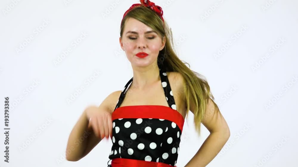 A beautiful 50s pin-up girl dances and smiles at the camera - white ...