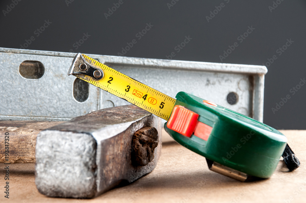 Ruler, hammer and level on the garage shelf Stock Photo | Adobe Stock