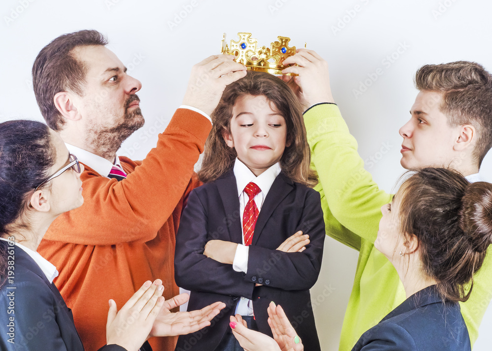 The hands of grown men wear a golden crown on a guy's head in a ...