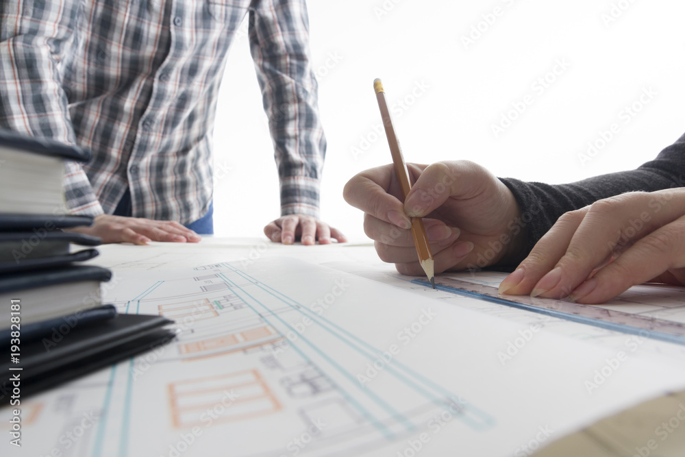 Architects working on blueprint, real estate project. Architect ...