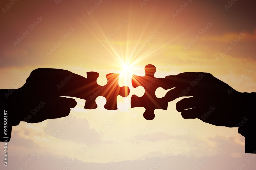 Teamwork, partnership and cooperation concept. Silhouettes of two hands ...