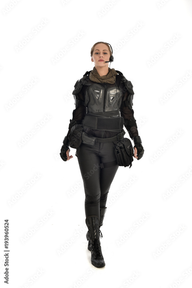 full length portrait of female soldier wearing black tactical armour ...